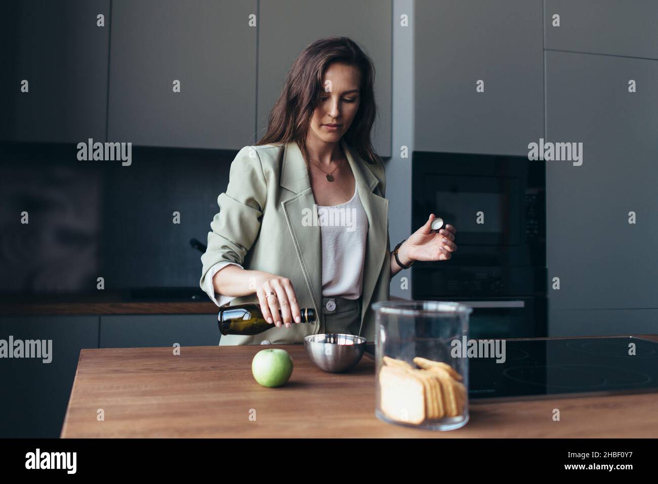 Woman having breakfast before leaving for work Stock Photo - Alamy