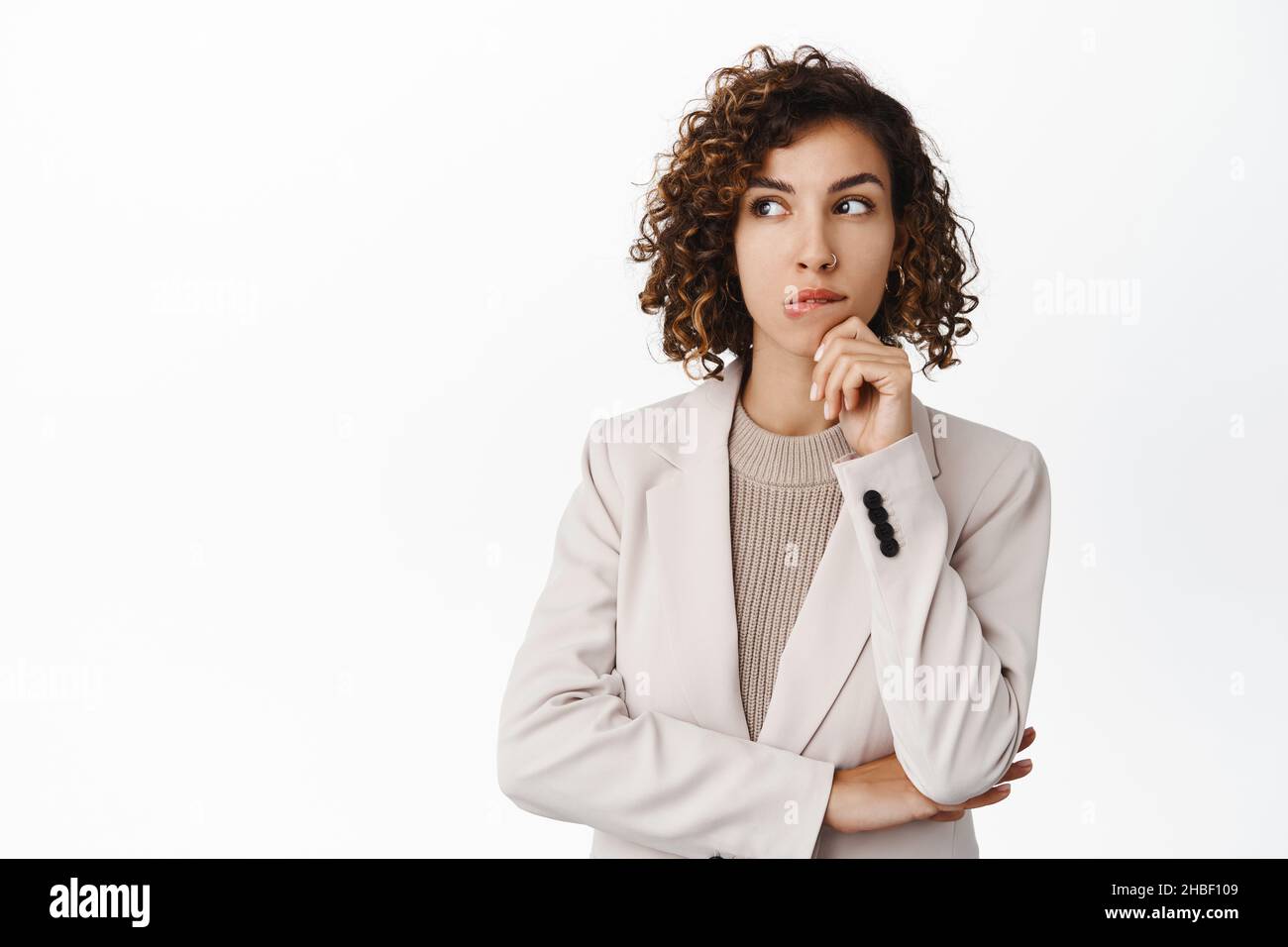 Thoughtful corporate woman looking away, brainstorming, thinking of ...