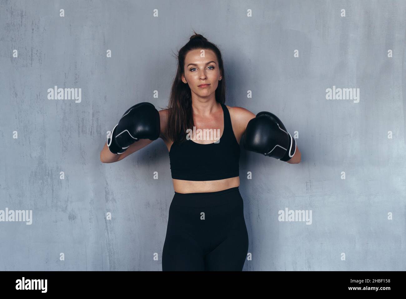 Female amateur boxer poses in boxing gloves Stock Photo - Alamy