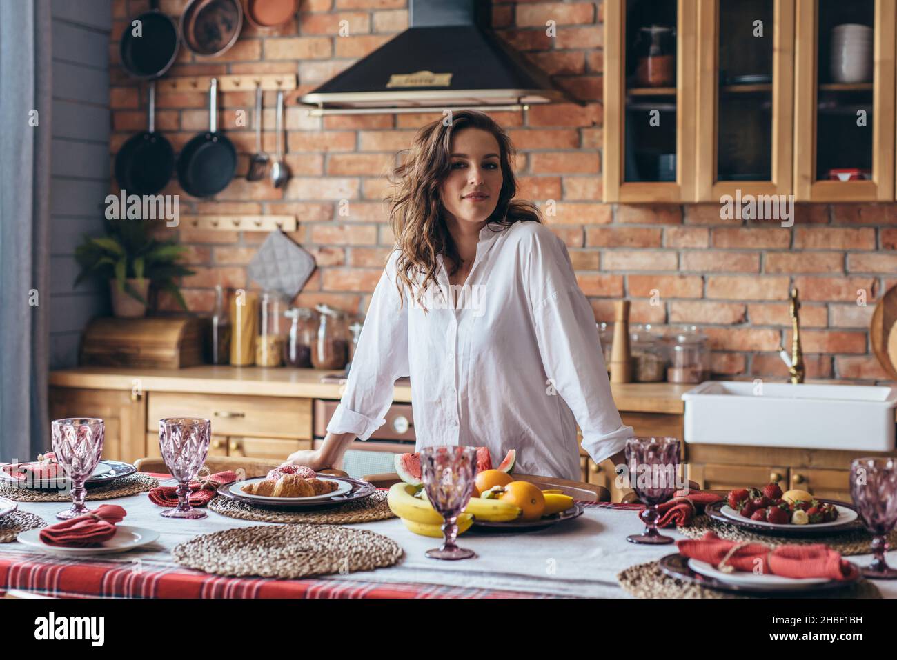 Woman has set the table and is ready to welcome guests Stock Photo - Alamy