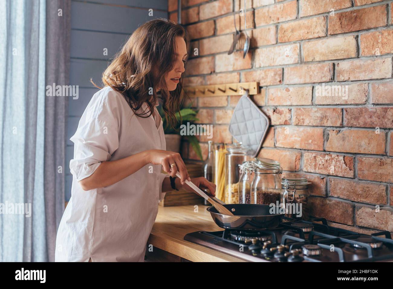 Person stirring food in pan hi-res stock photography and images - Alamy