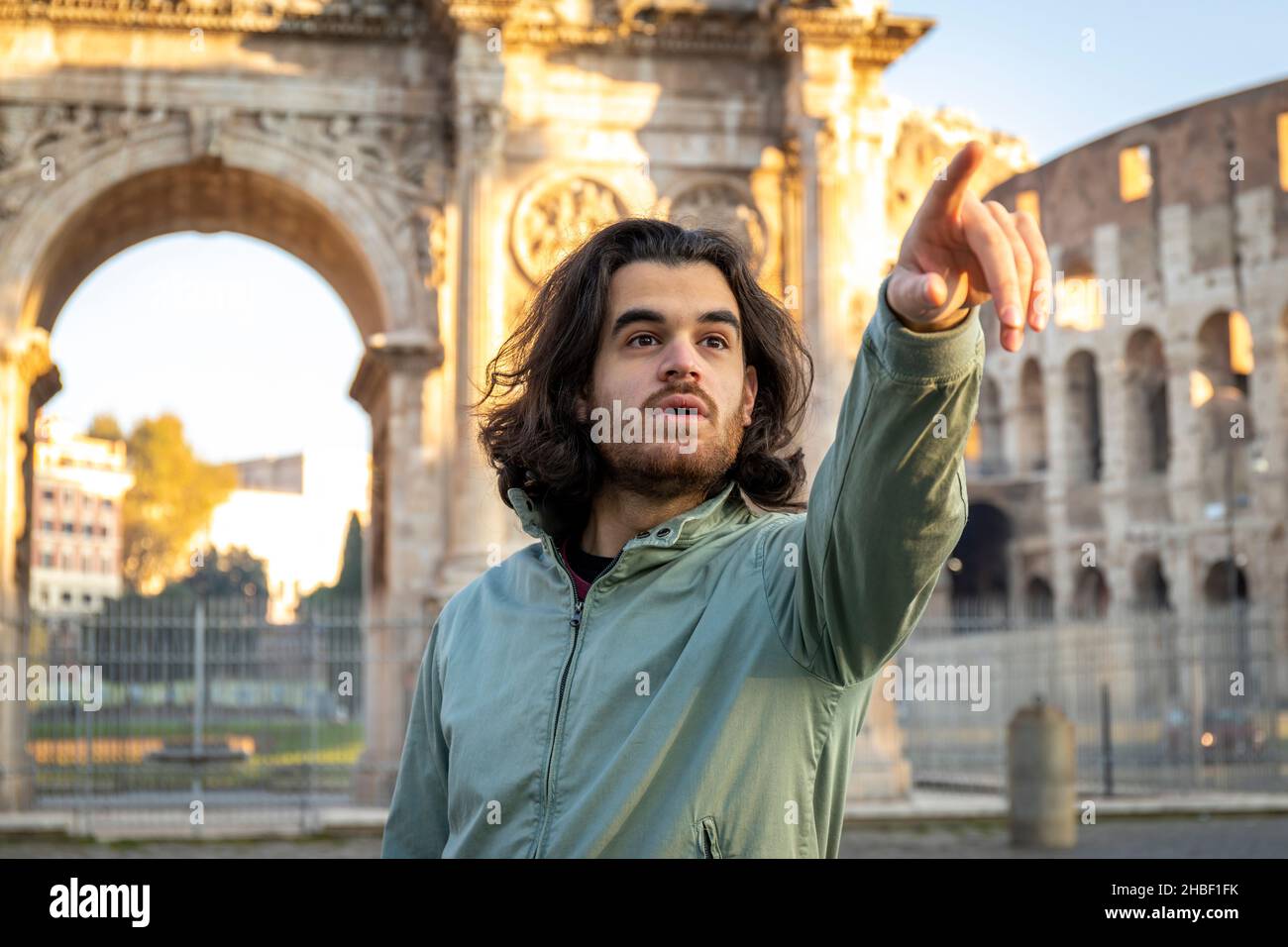 Beautiful man poses for a photo in front of the Arch of Titus. The man ...