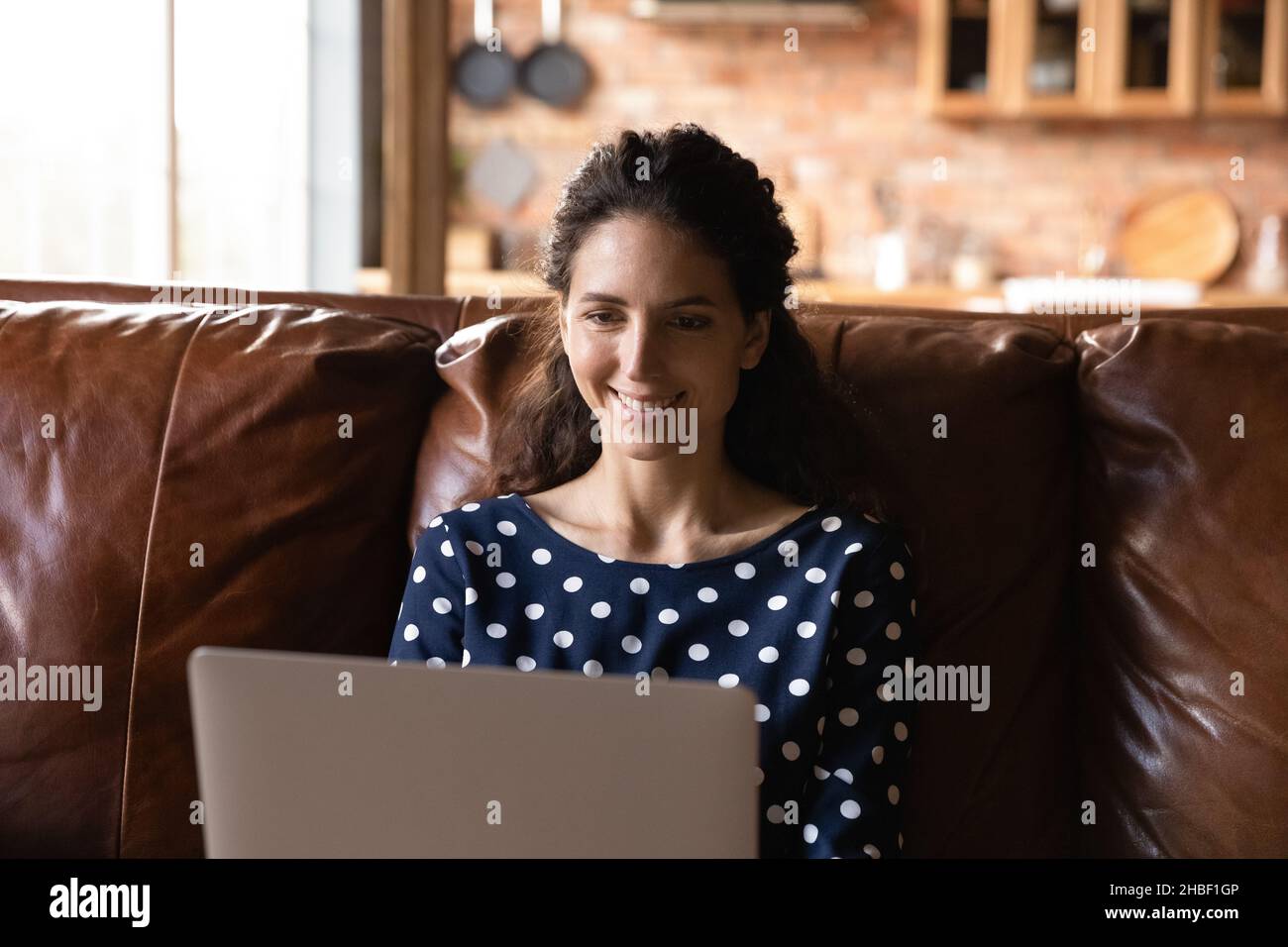 Smiling attractive millennial hispanic woman working on computer Stock ...