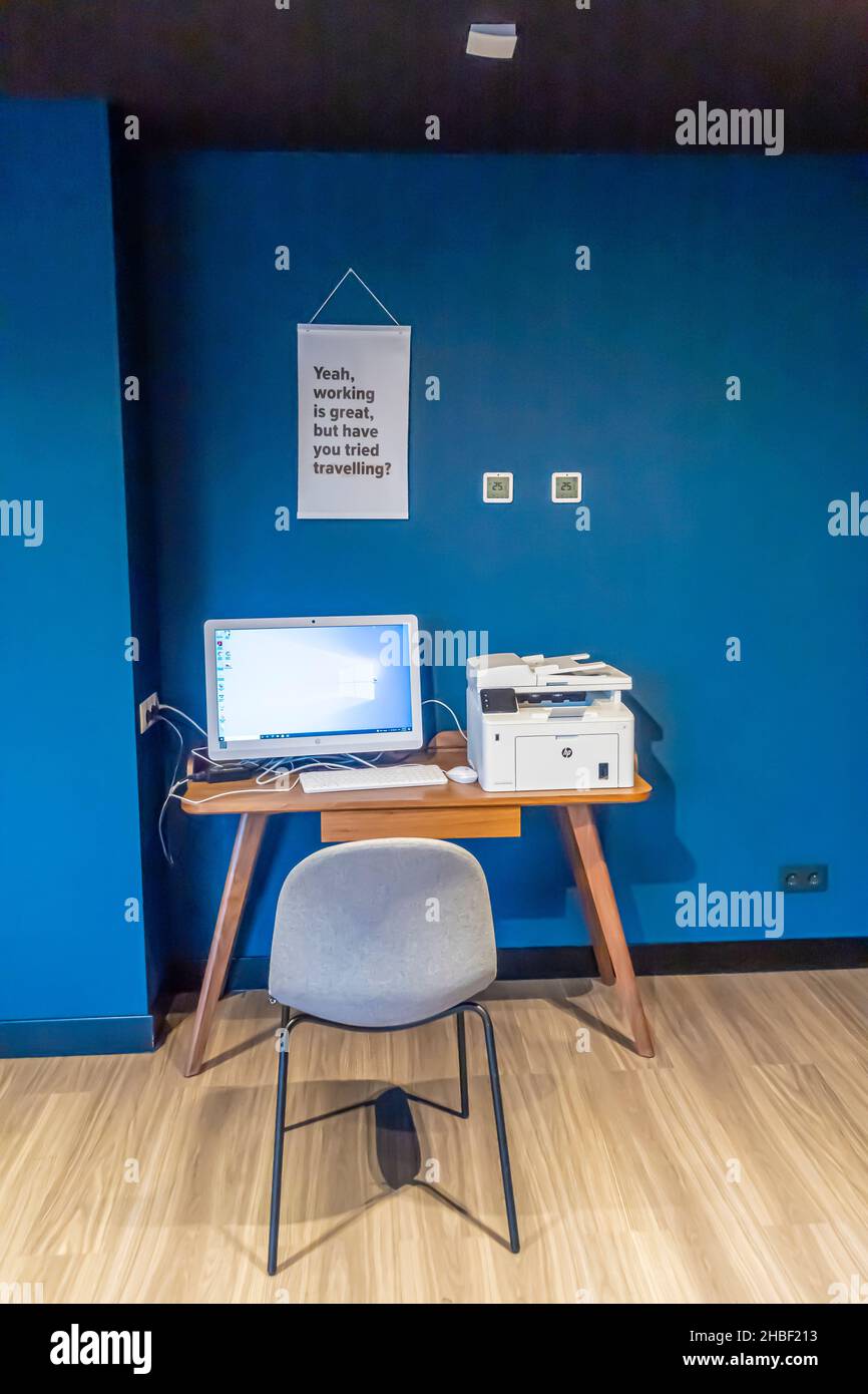 Desk with computer, printer on tha table in the lobby hall of the hotel ...