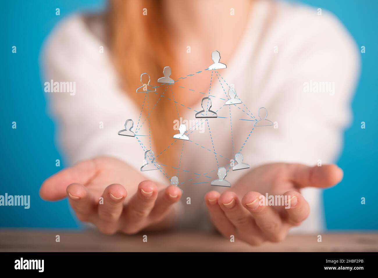 An abstract shot of woman's hands displaying contact icons connecting ...