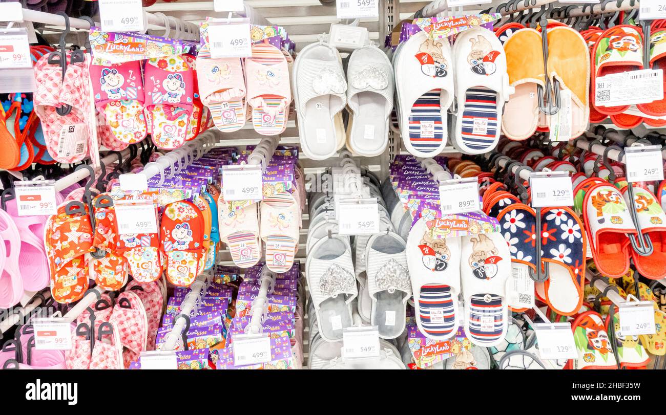 Affordable slippers for wearing home on display in Auchan store, Moscow ...
