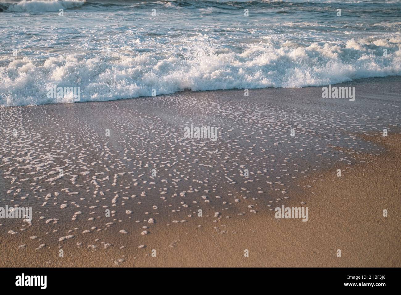 The foamy surf on Atlantic beach Stock Photo - Alamy