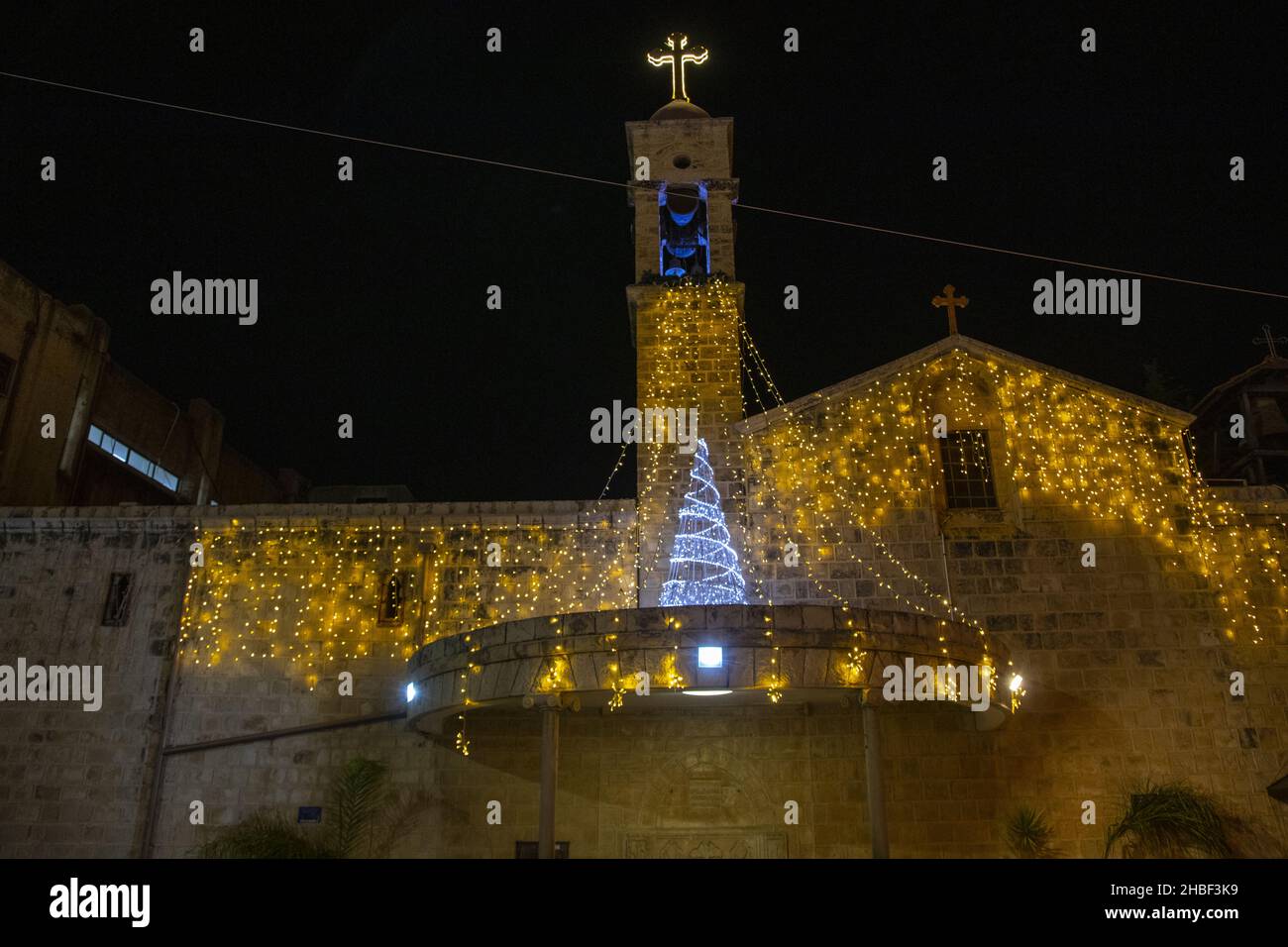 light decorations and christmas trees during new year celebration in ...