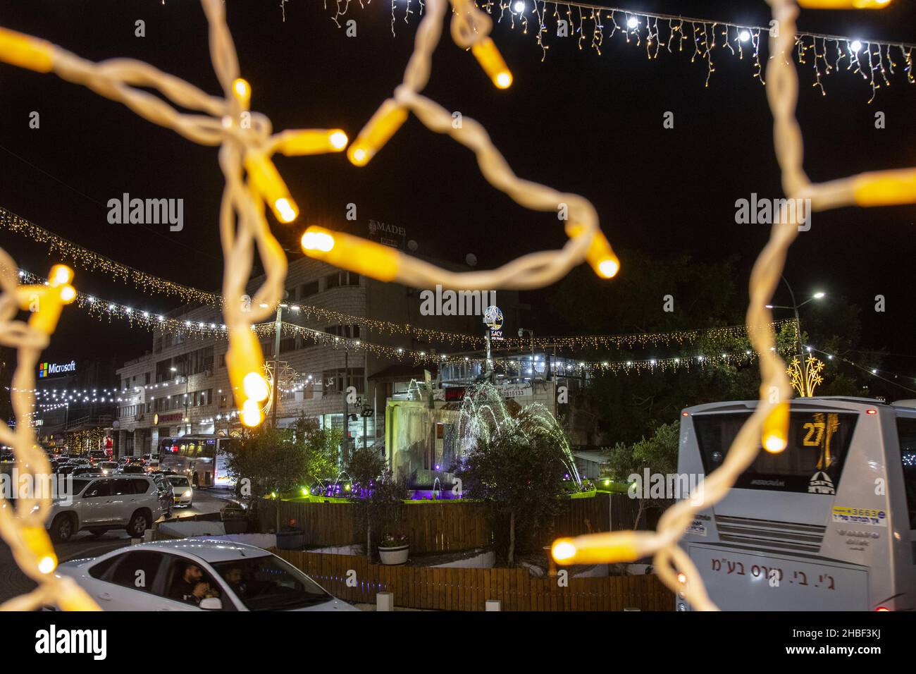 light decorations and christmas trees during new year celebration in ...
