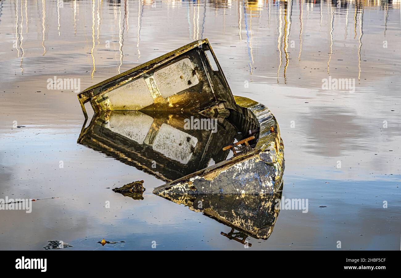 A view of a wrecked boat in the water and its reflection Stock Photo ...