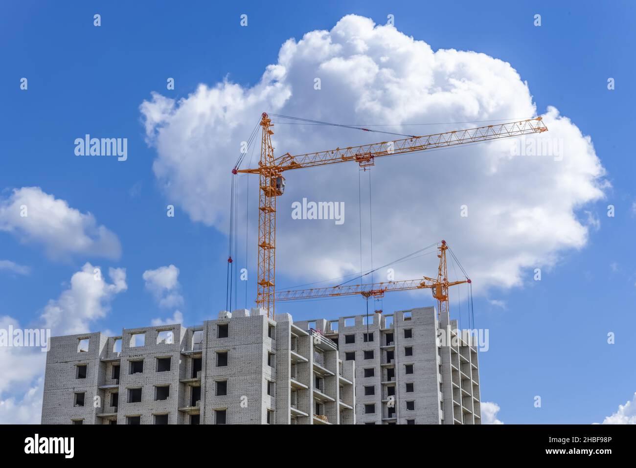 Highrise building and hoisting crane Stock Photo - Alamy
