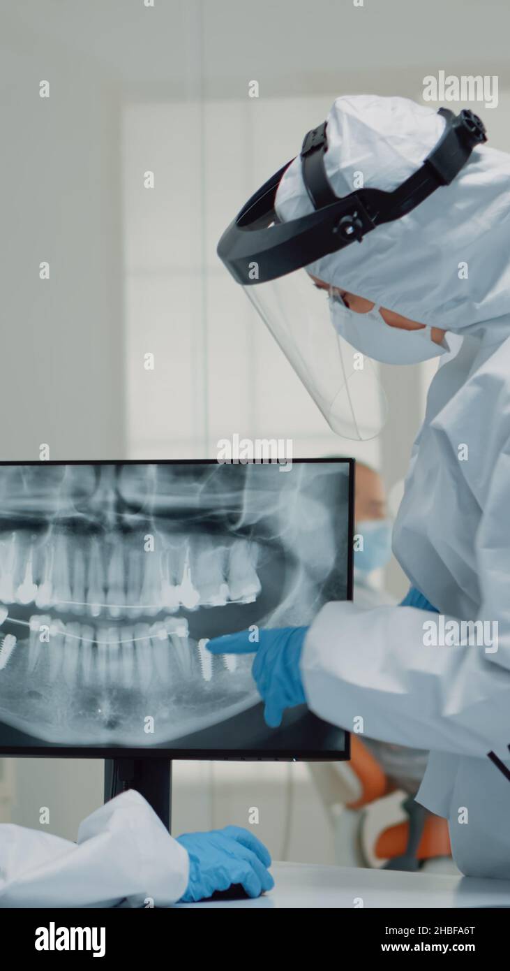 Professional stomatologist looking at teeth animation on screen and ...