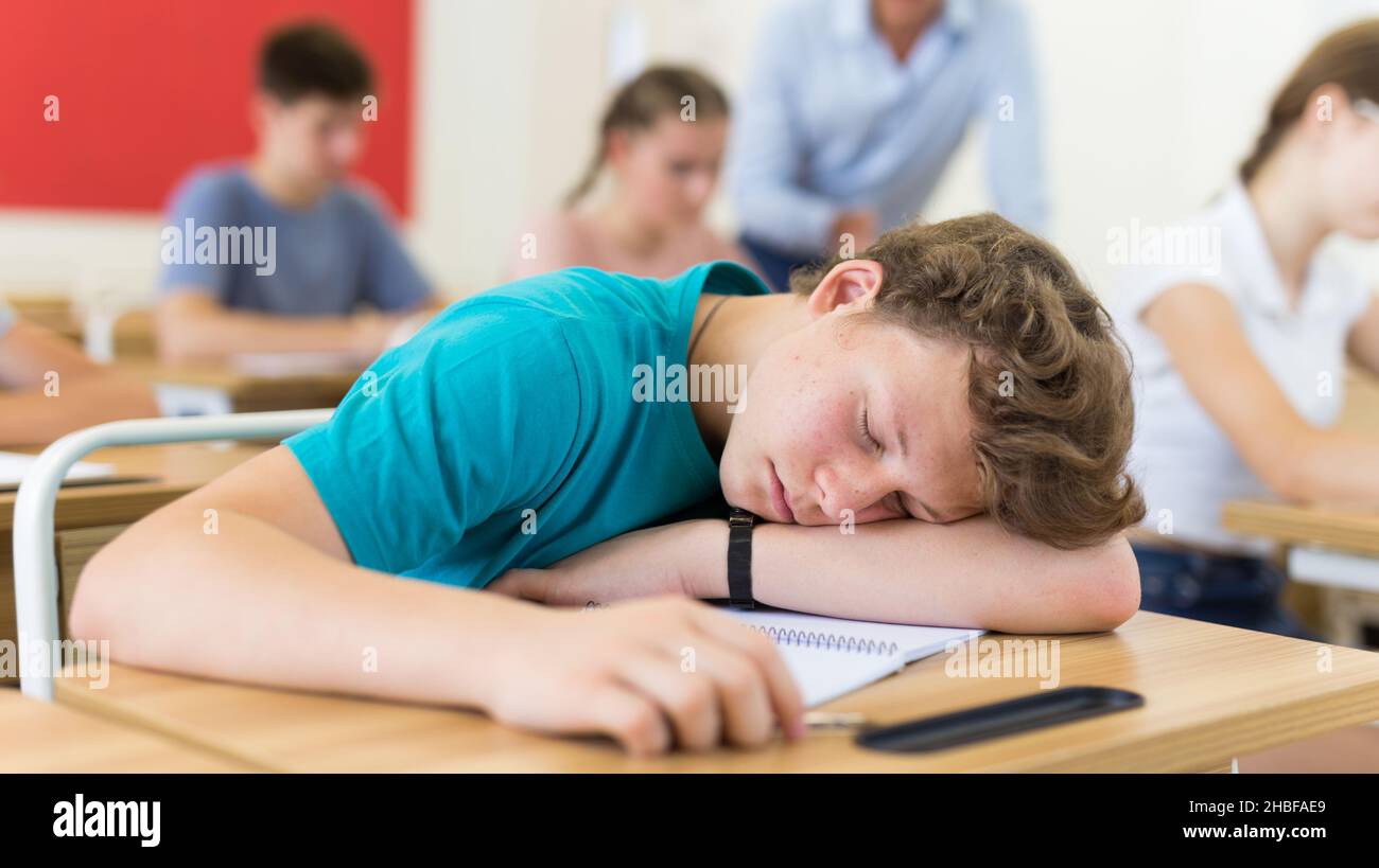 Tired student fell asleep on desk in class Stock Photo - Alamy