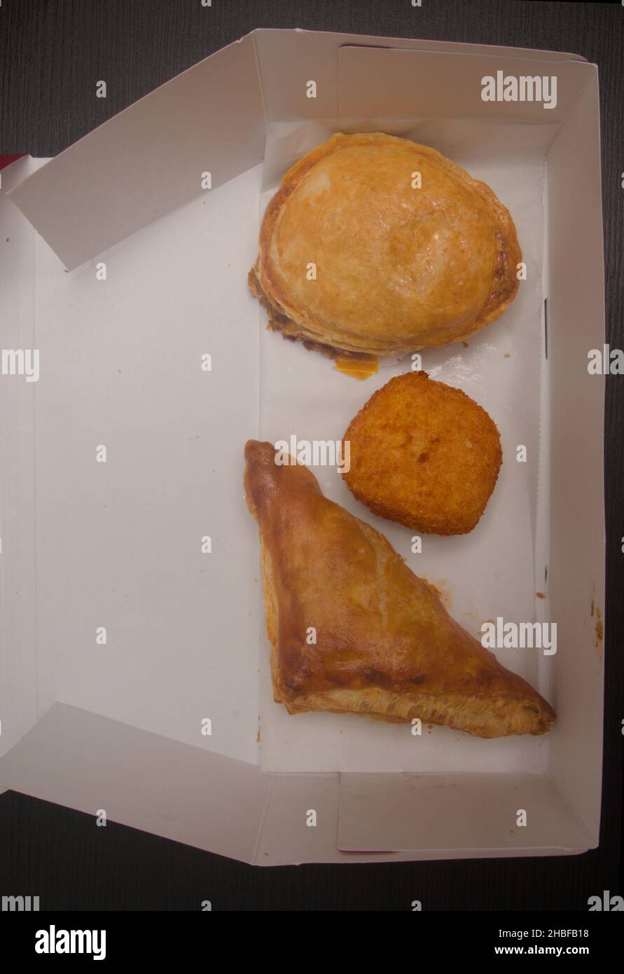 Delicious created pastries in box. Who's hungry? meat pie, potato ball ...