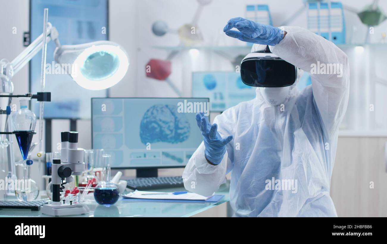 Scientist researcher doctor wearing virtual reality headset analyzing ...