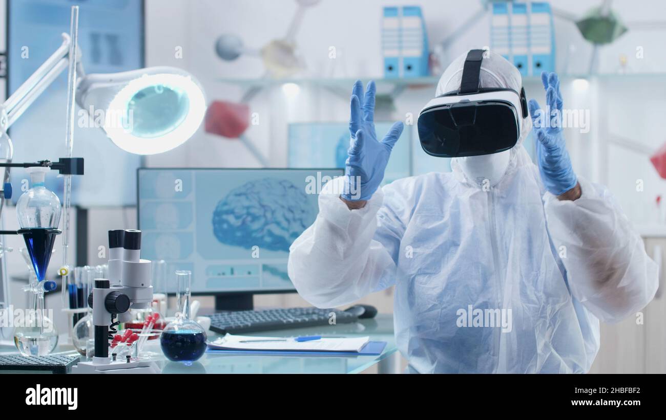 Specialist researcher doctor wearing virtual reality headset analyzing ...