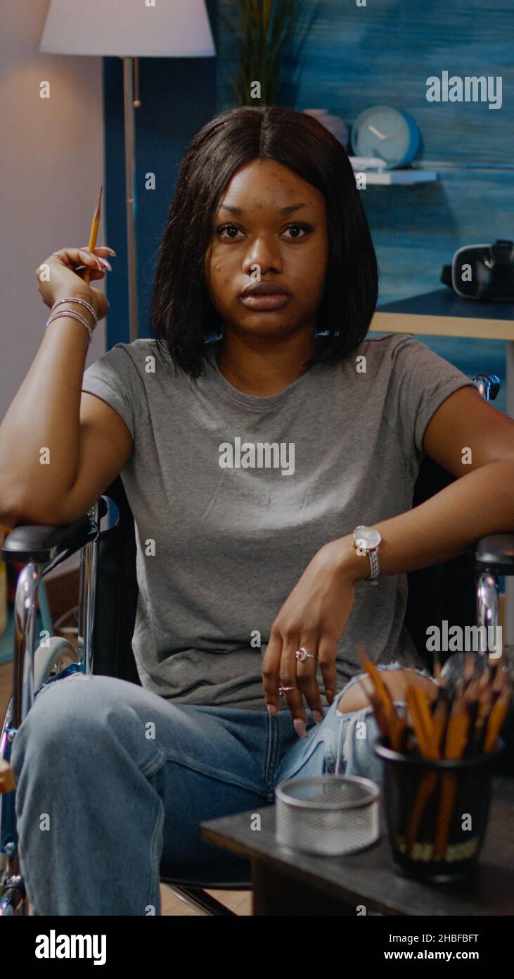 Portrait of disabled african american artist sitting in art studio ...