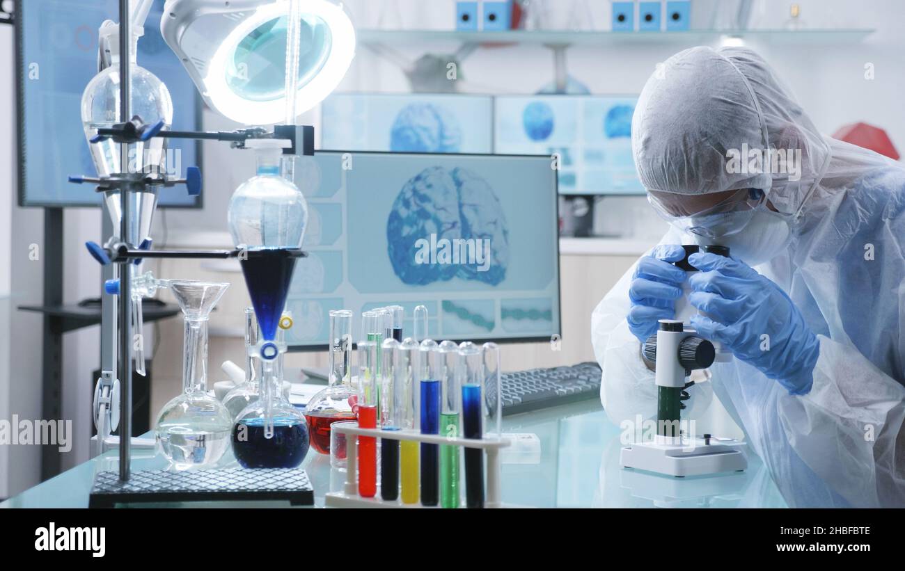 Chemist researcher doctor with ppe equipment analyzing dna sample using ...