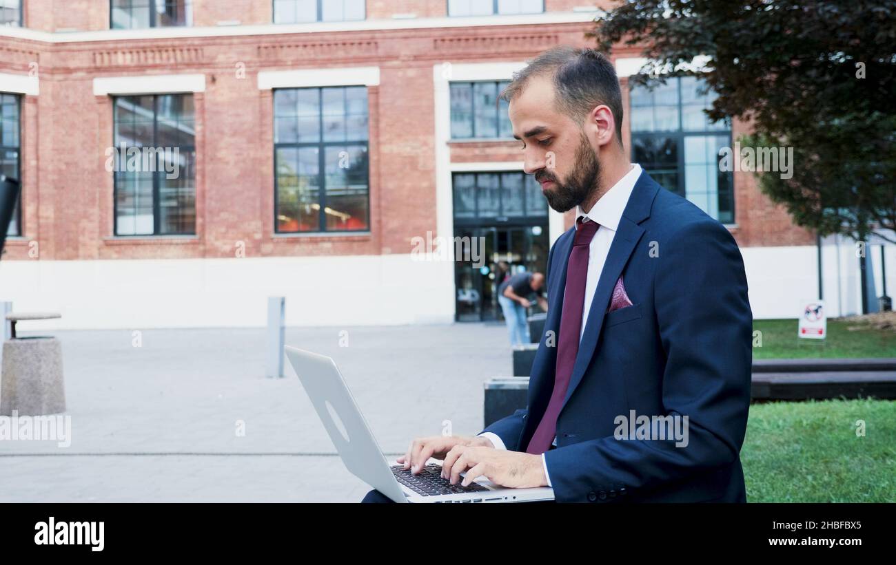 Entrepreneur man in diplomatic suit holding laptop computer working at ...