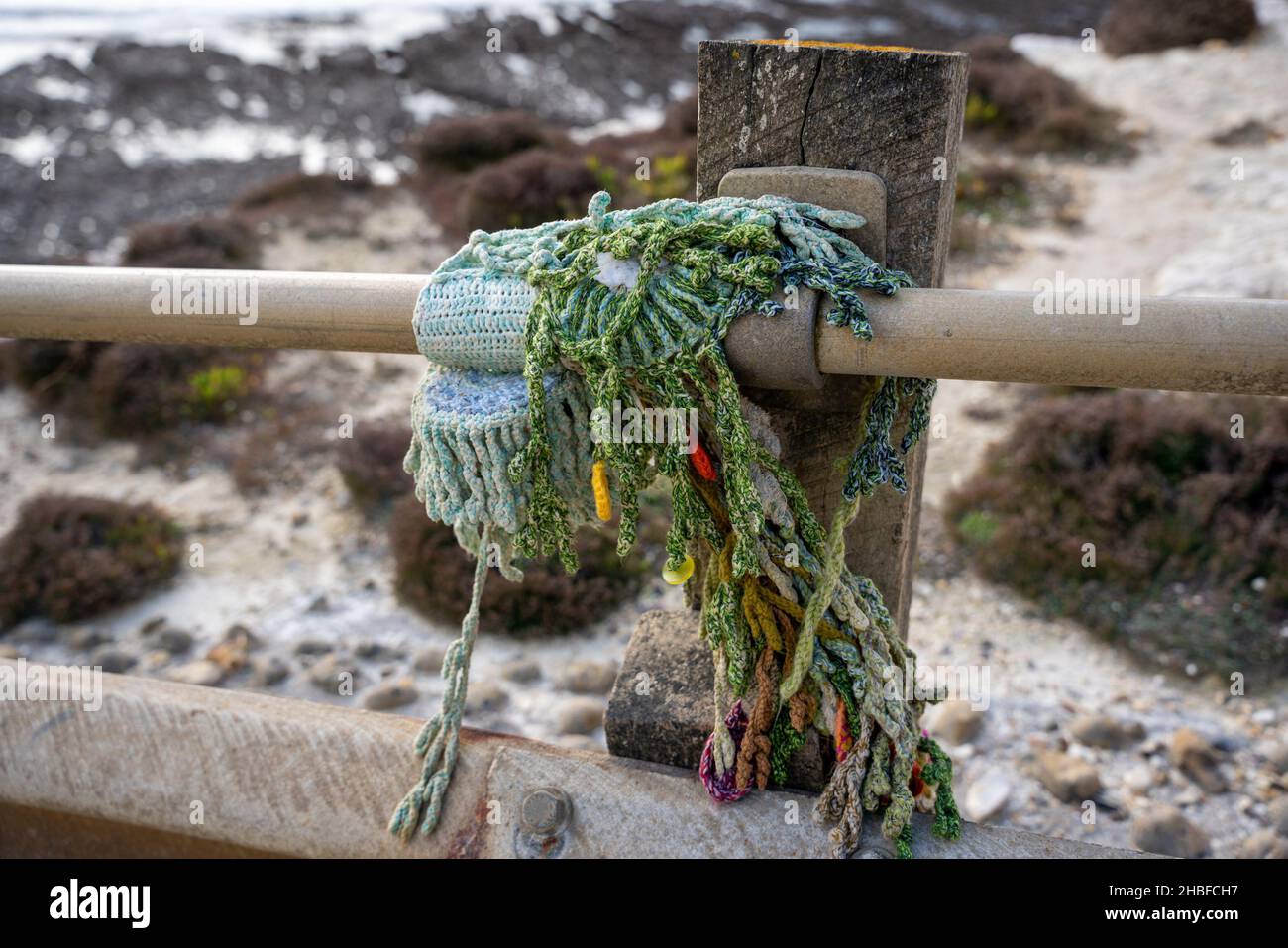 A horizontal handle wooden pipe designed with knotted ropes on the ...