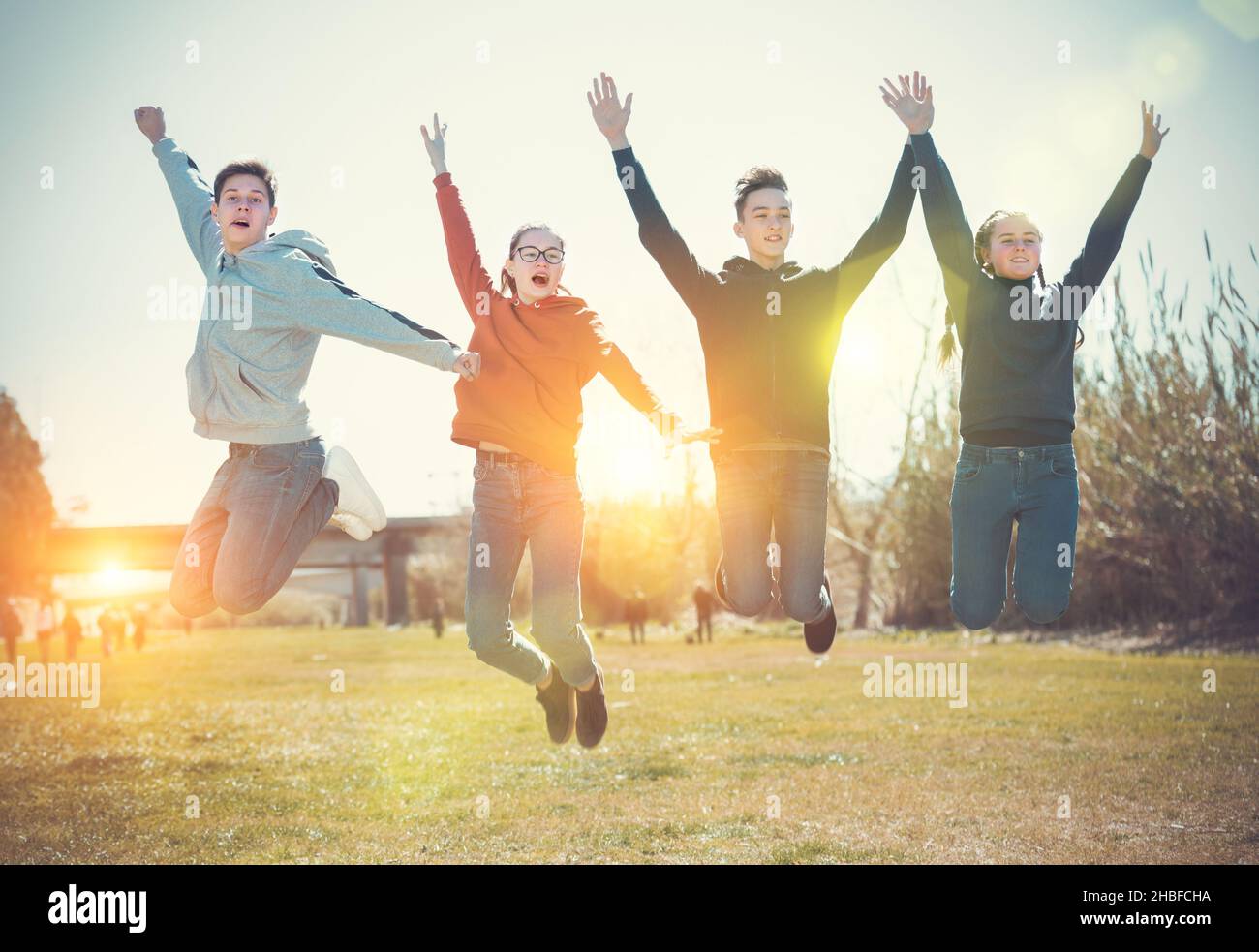 Portrait four happy friends jumping hi-res stock photography and images ...