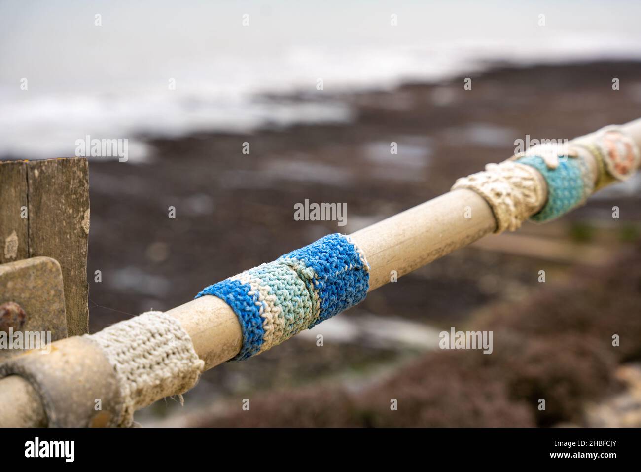 A horizontal handle wooden pipe designed with knotted ropes on the ...