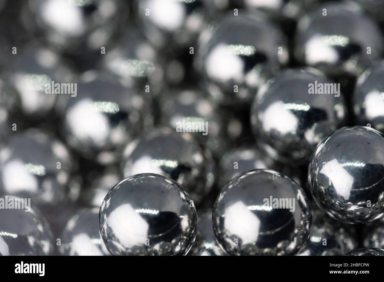 Metal balls arranged side by side to form an organized structure. Macro ...