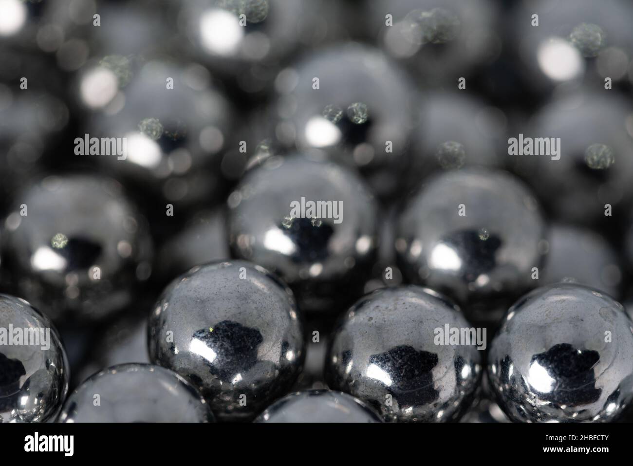 Metal balls arranged side by side to form an organized structure. Macro ...