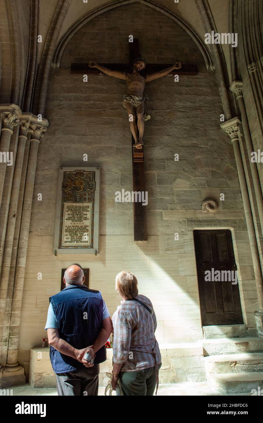 Couple admiring the statue of Jesus Christ on the Crucifix in a Church ...