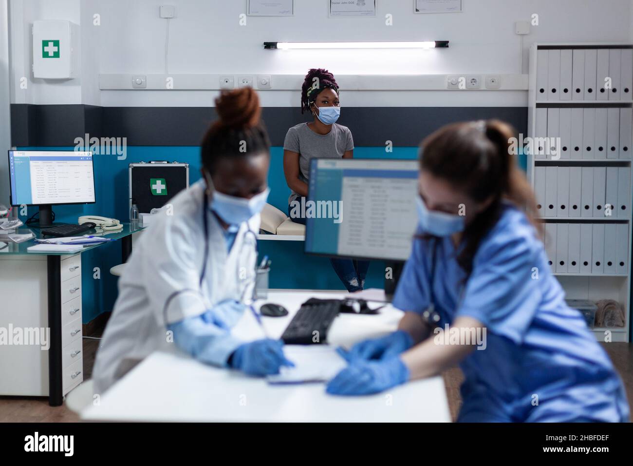 Medical team with protective face mask to prevent infection with ...