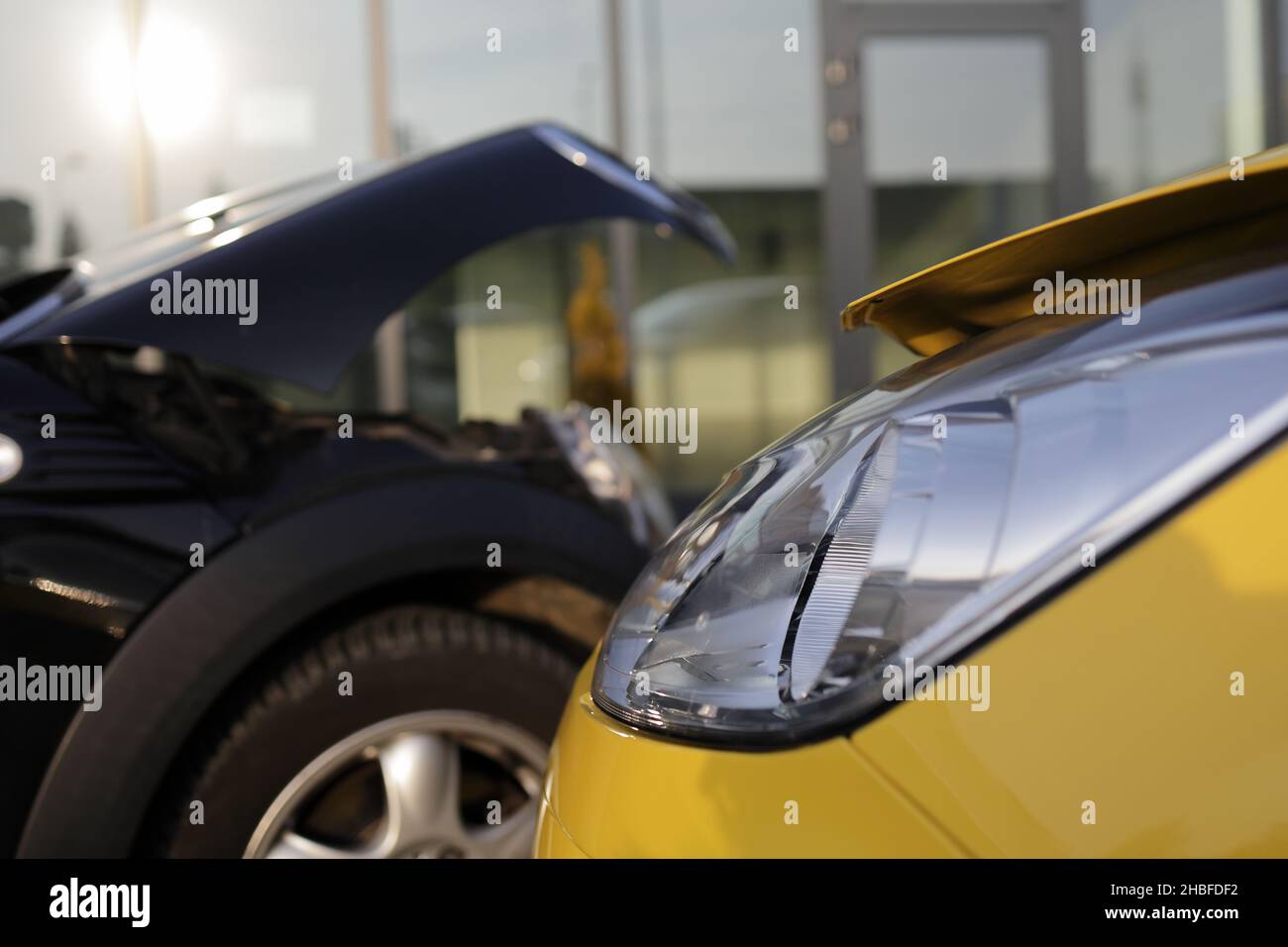 A car accident between a yellow and a black car Stock Photo - Alamy