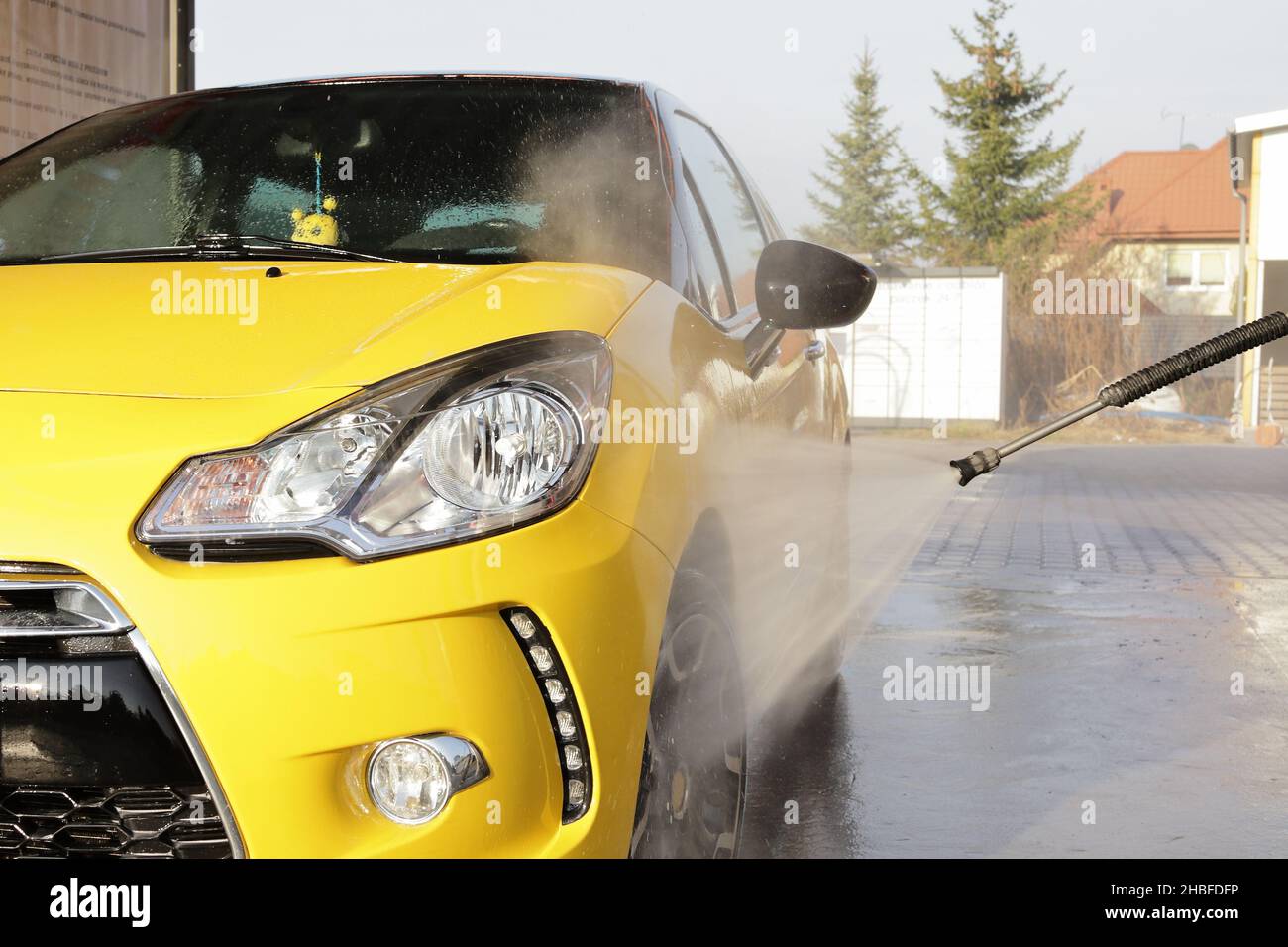 A person washing a yellow car in a car wash Stock Photo - Alamy