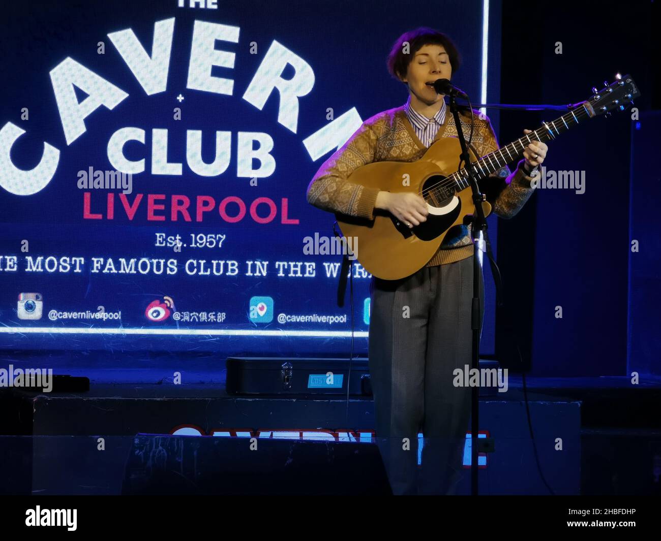 LIVERPOOL, UNITED KINGDOM - Nov 11, 2021: A woman playing guitar and ...