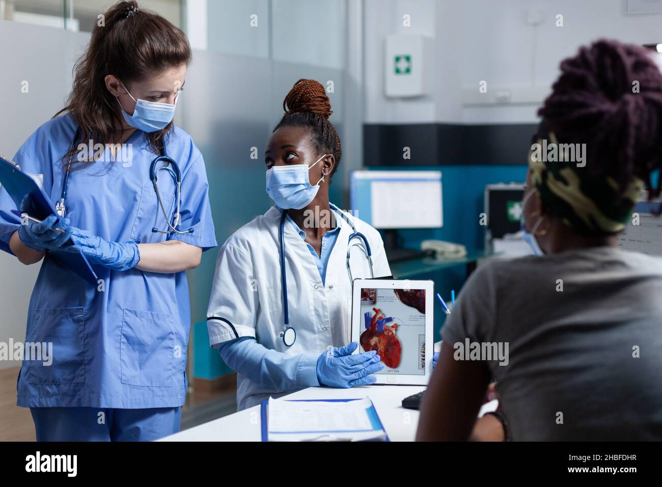 African american cardiologist doctor showing heart radiohraphy to sick ...