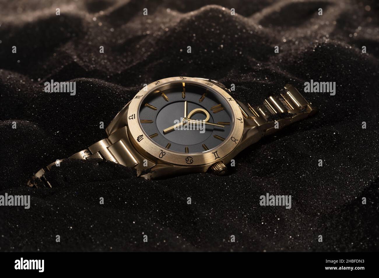An Ankh themed watch on black sand Stock Photo - Alamy