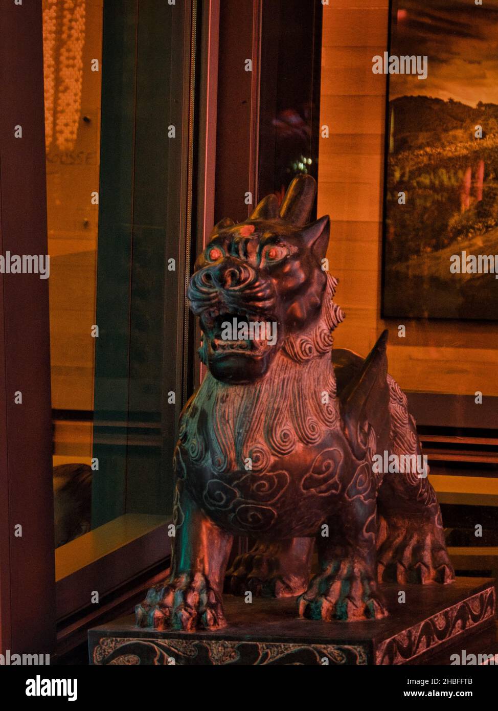 A vertical shot of a Gargoyle statue outdoors at night in Las Vegas ...