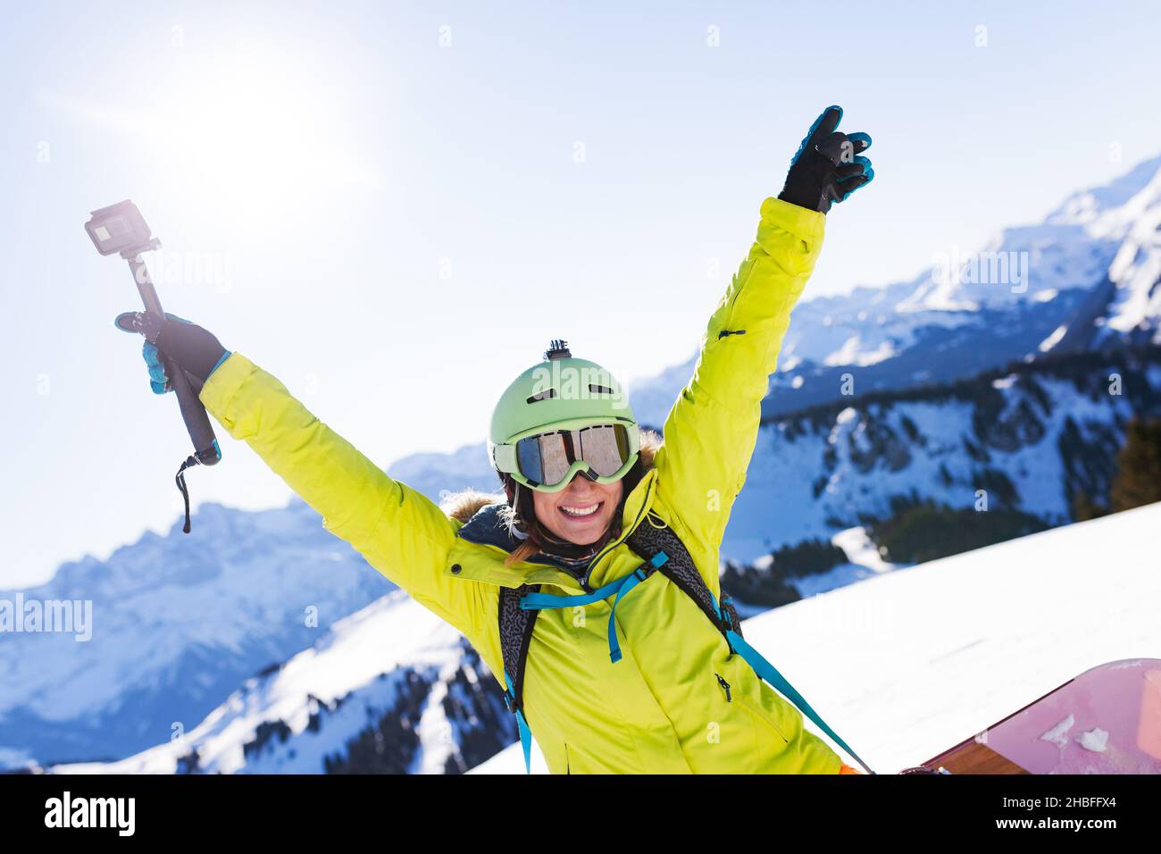 snowboarded girl posing on the snow with action camera Stock Photo - Alamy