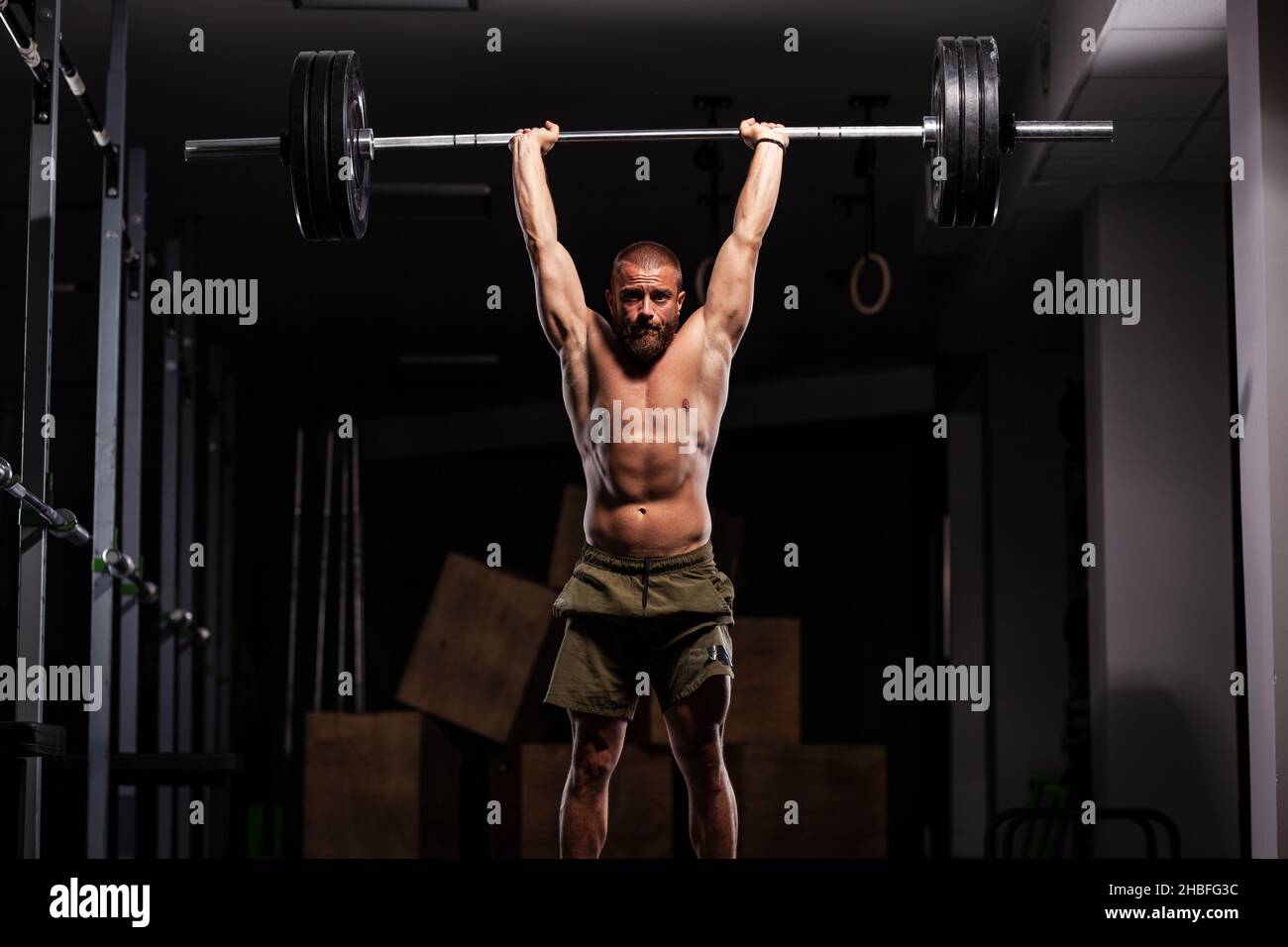 Muscular athlete lifting very heavy barbell Stock Photo - Alamy