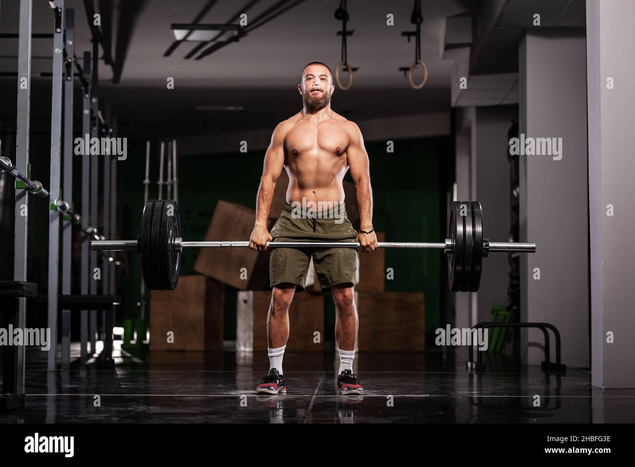 Muscular athlete lifting very heavy barbell Stock Photo - Alamy