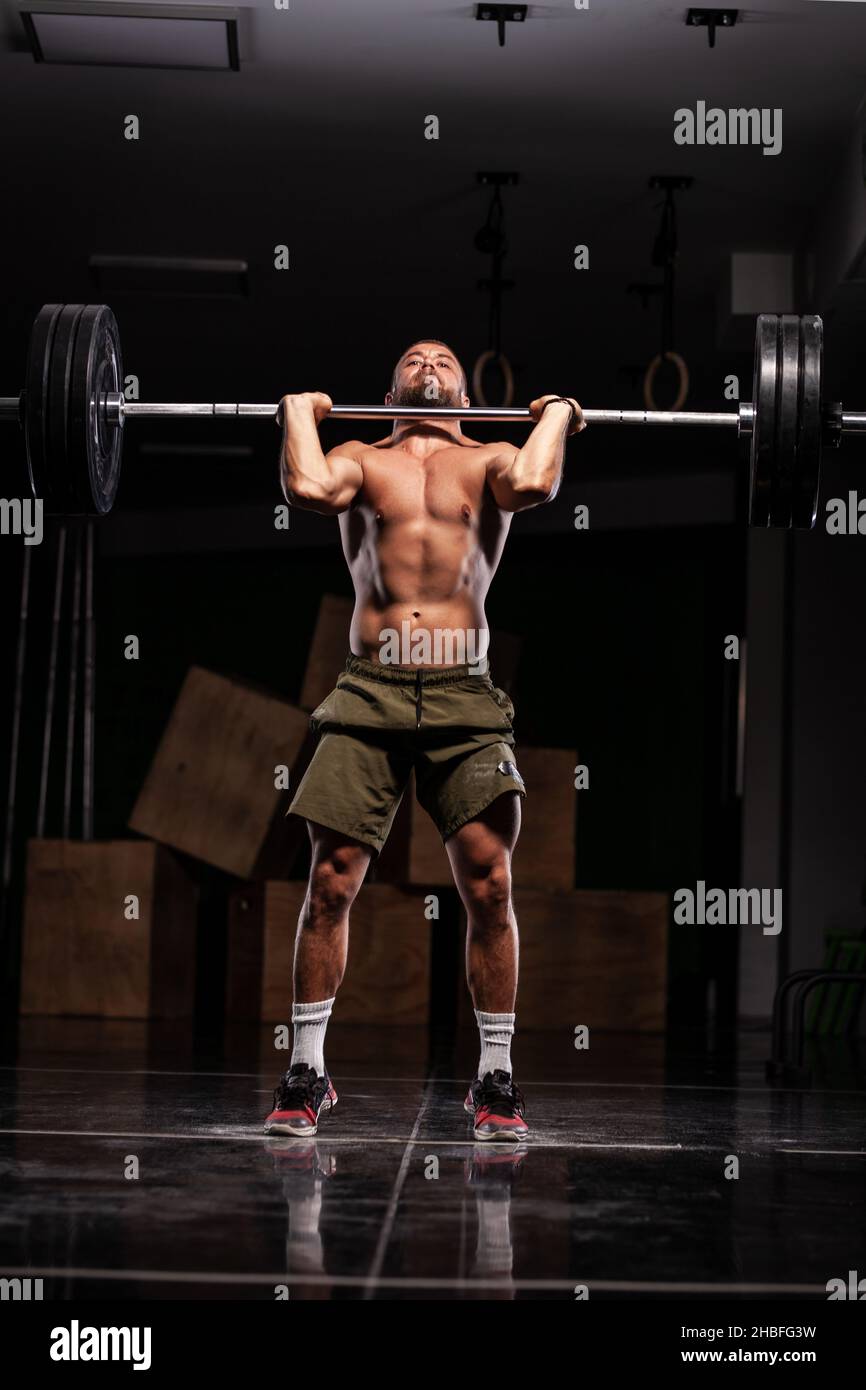 Muscular athlete lifting very heavy barbell Stock Photo - Alamy