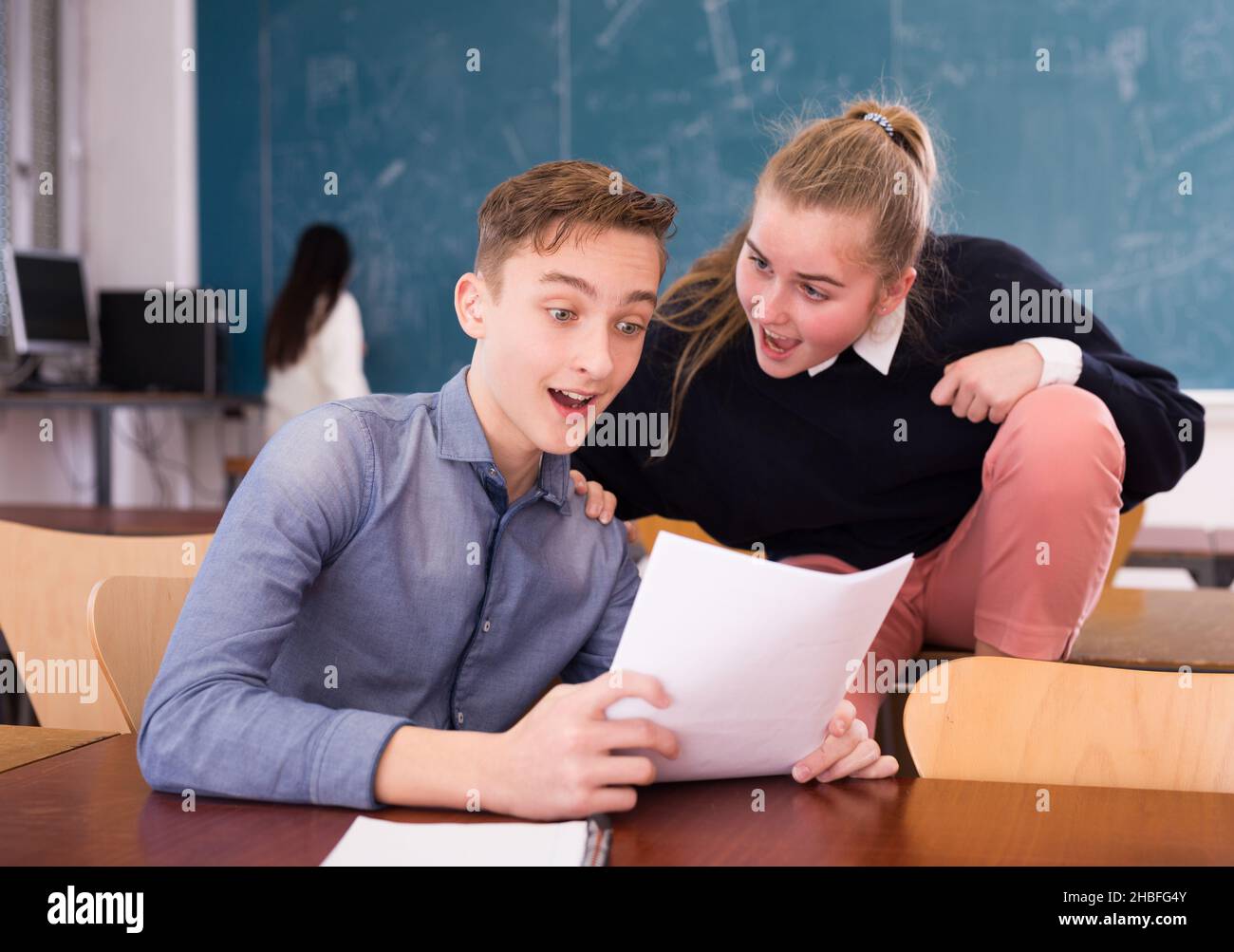 Two university students sitting at desk and learning homework Stock ...