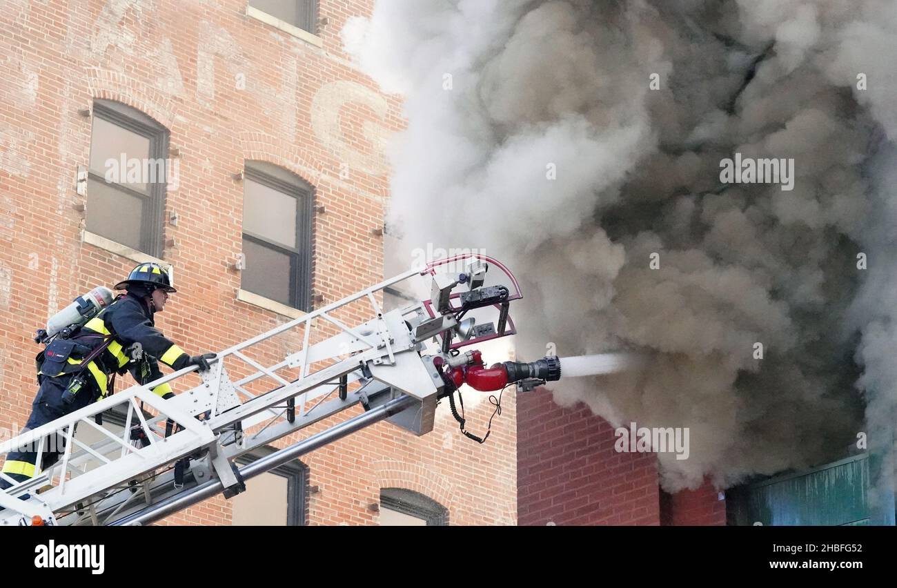 St. Louis, United States. 19th Dec, 2021. A St. Louis firefighter backs ...