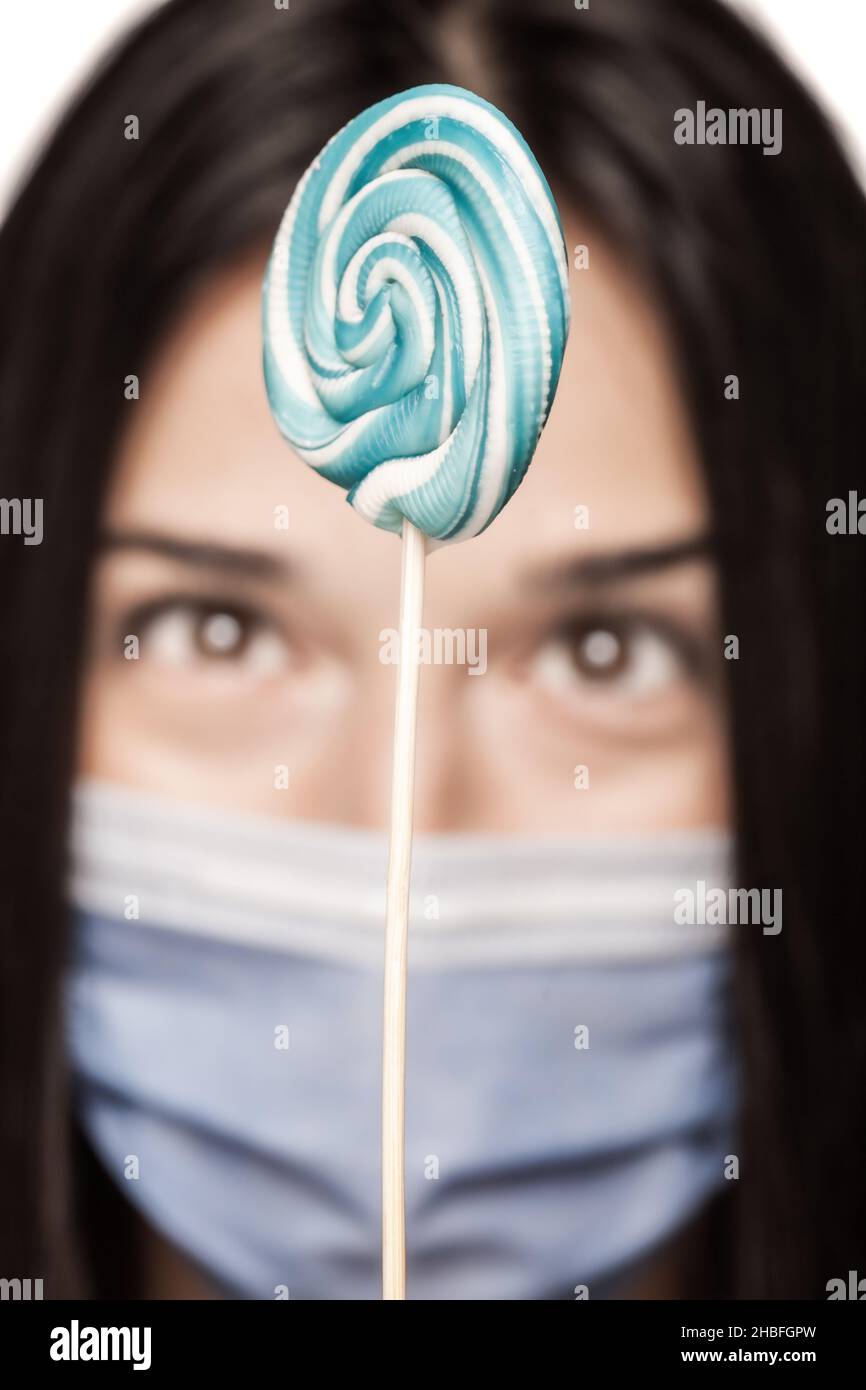 Girl having her mouth covered with with medical face mask holding ...