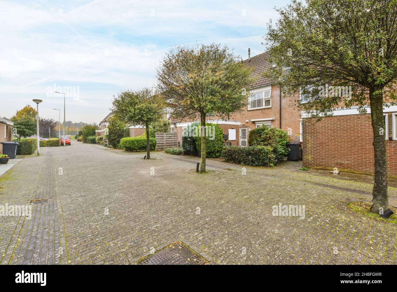 A spotless street with brick houses and trees Stock Photo - Alamy