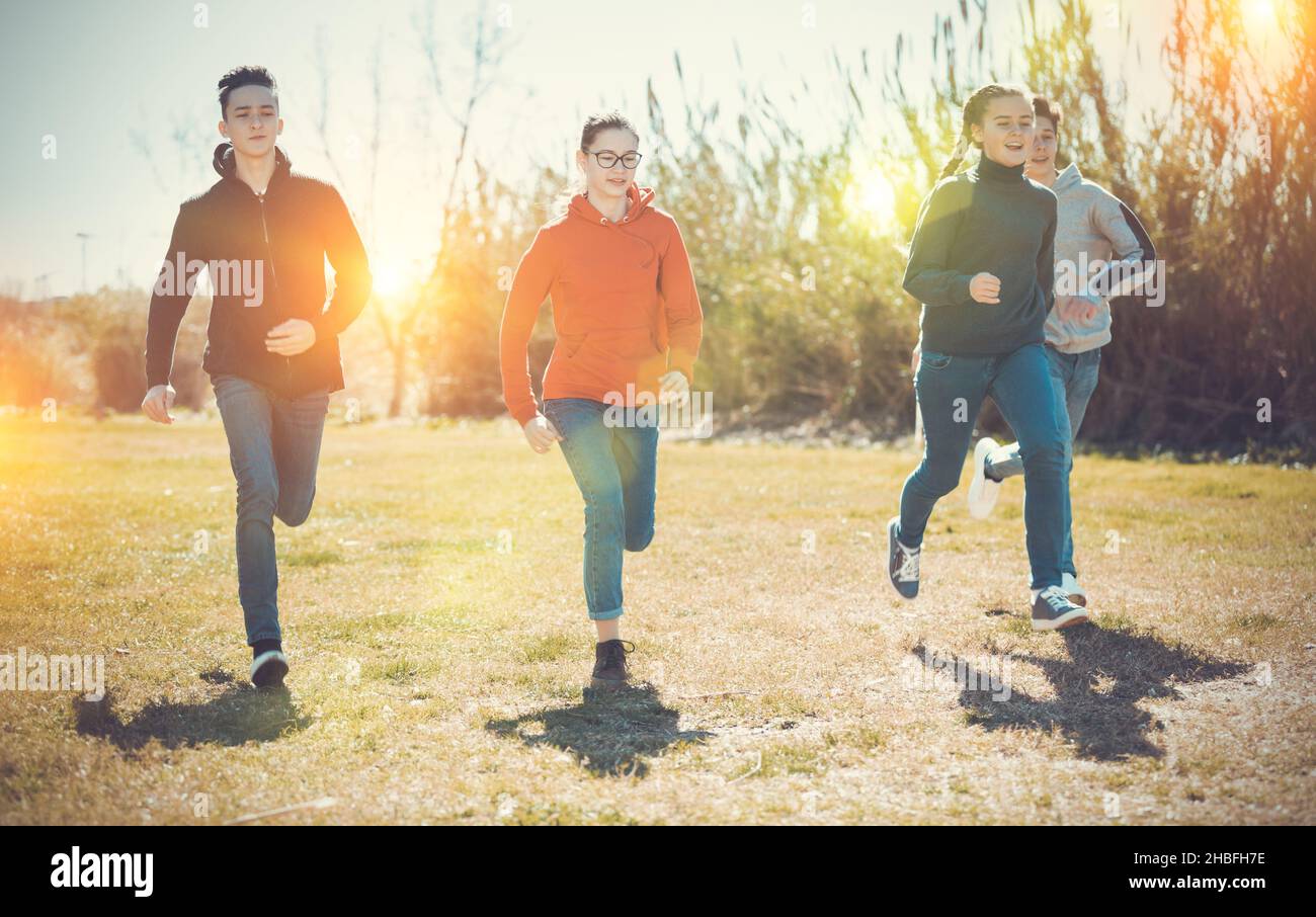 Happy group children playing chasing hi-res stock photography and ...