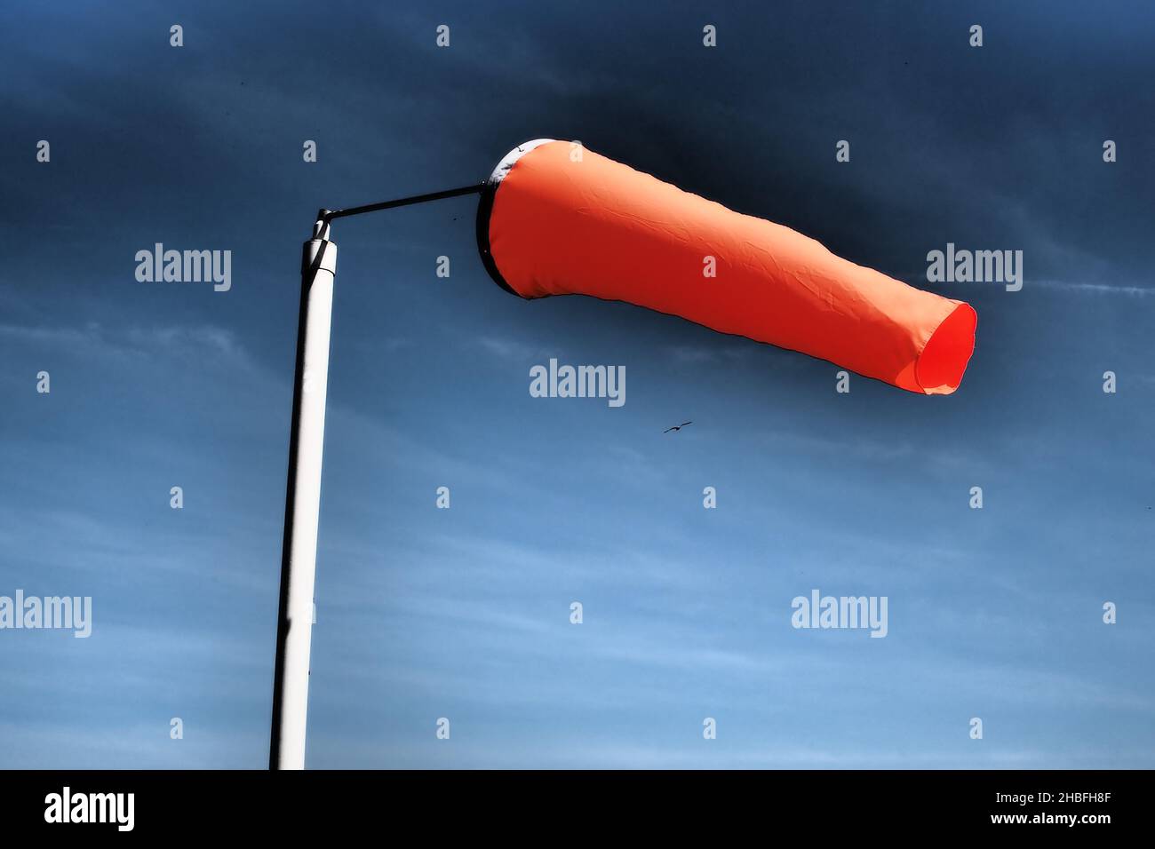 A shot of the orange wind sock with sky in the background Stock Photo ...