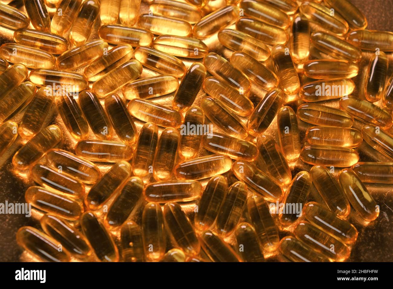 Fish oil capsules background. omega fatty acids.Fish Oil Capsules gold ...