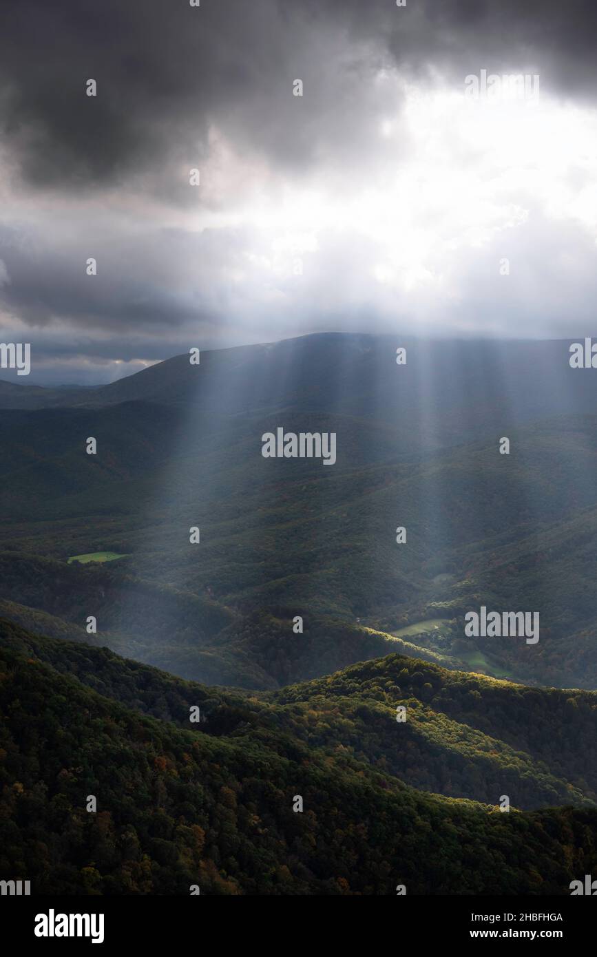 An intense display of crepuscular rays of light illuminating down into ...