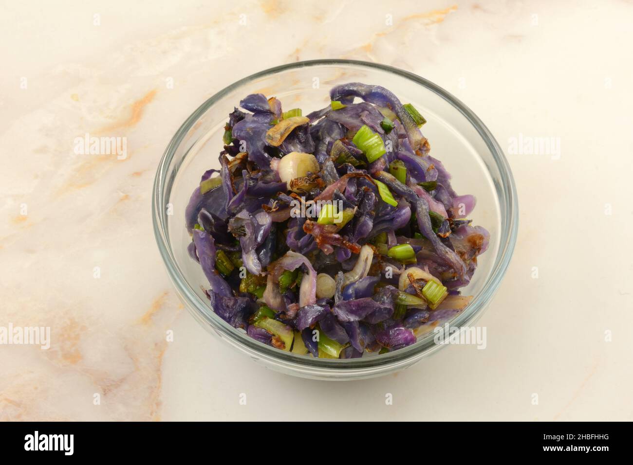 Cooked sliced red cabbage and green onions in glass ingredient bowl ...