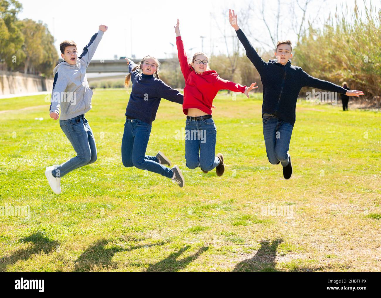 Portrait four happy friends jumping hi-res stock photography and images ...